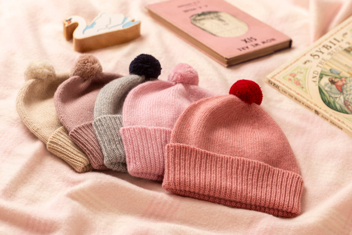 Rosie Sugden Cashmere’s Baby Beanie in Dusky pink + regal red pom